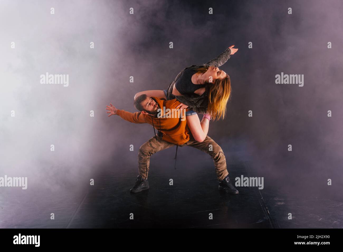 Strong male dancer and an elegant female dancer perform an exotic and ...