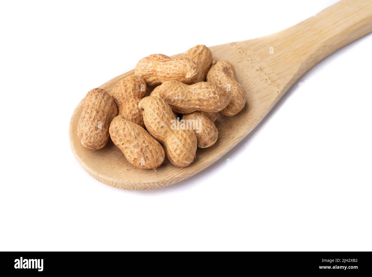 Shelled peanuts in a spoon isolated over white background Stock Photo ...