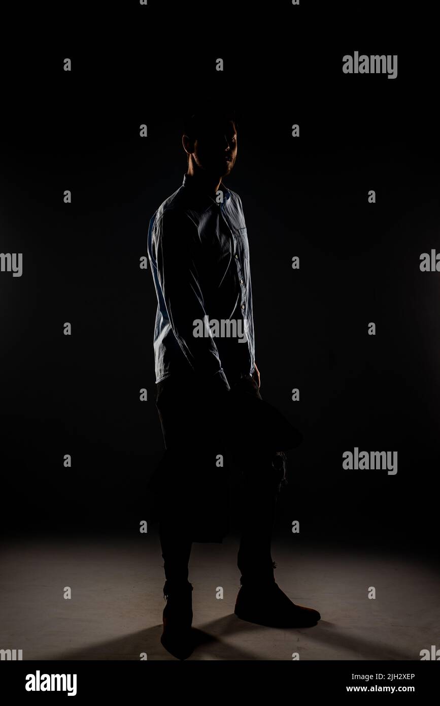 Tall and handsome male posing in the studio with dimmed lights Stock ...