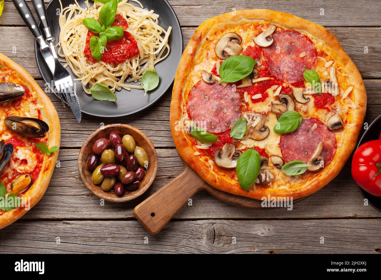 Italian cuisine. Pasta, pizza, olives and antipasto toasts. Flat lay ...