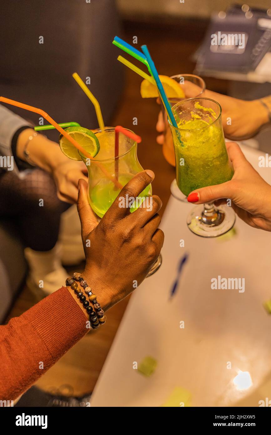 Group of friends are doing cheers with the drinks all together, close ...