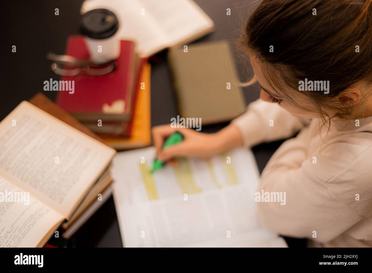 Upper angle of a girl underlining on a desk in a library Stock Photo ...