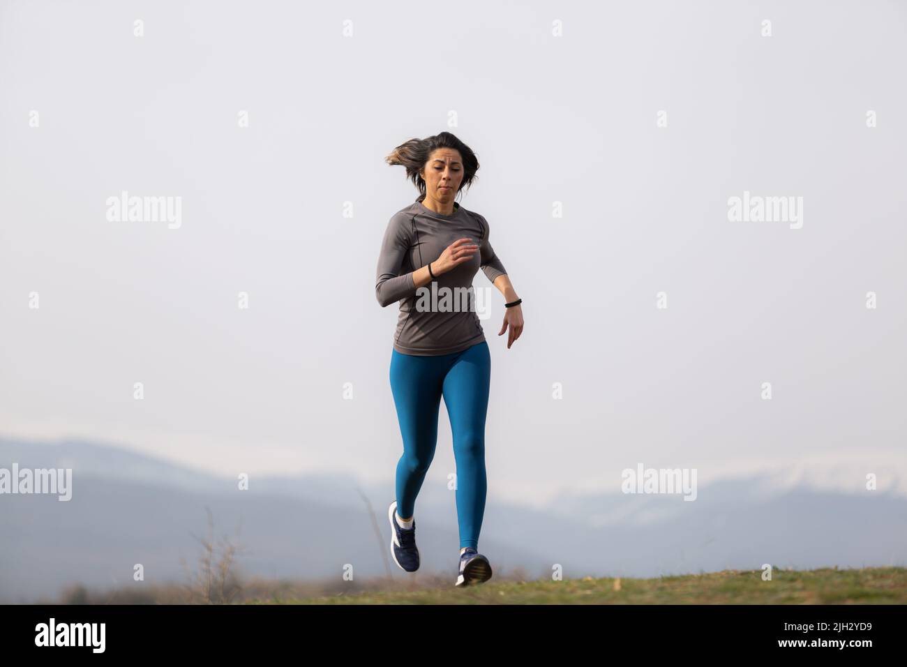 Amazing and active woman is running while looking down Stock Photo - Alamy