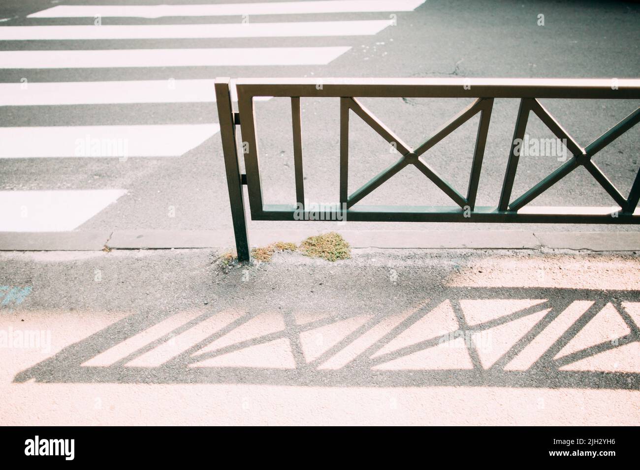Metal fence near road and crossing zebra Stock Photo - Alamy