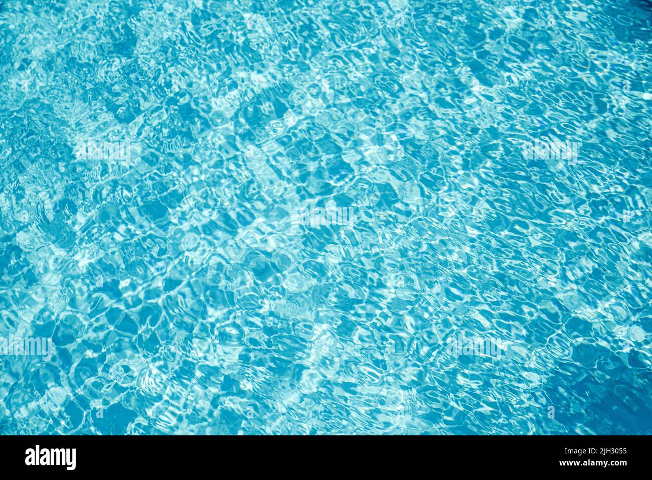 Transparent water in the pool with glare and waves, water abstract ...