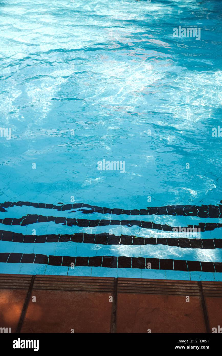 Stairs leading into the depths of the pool, clear water with ripples ...