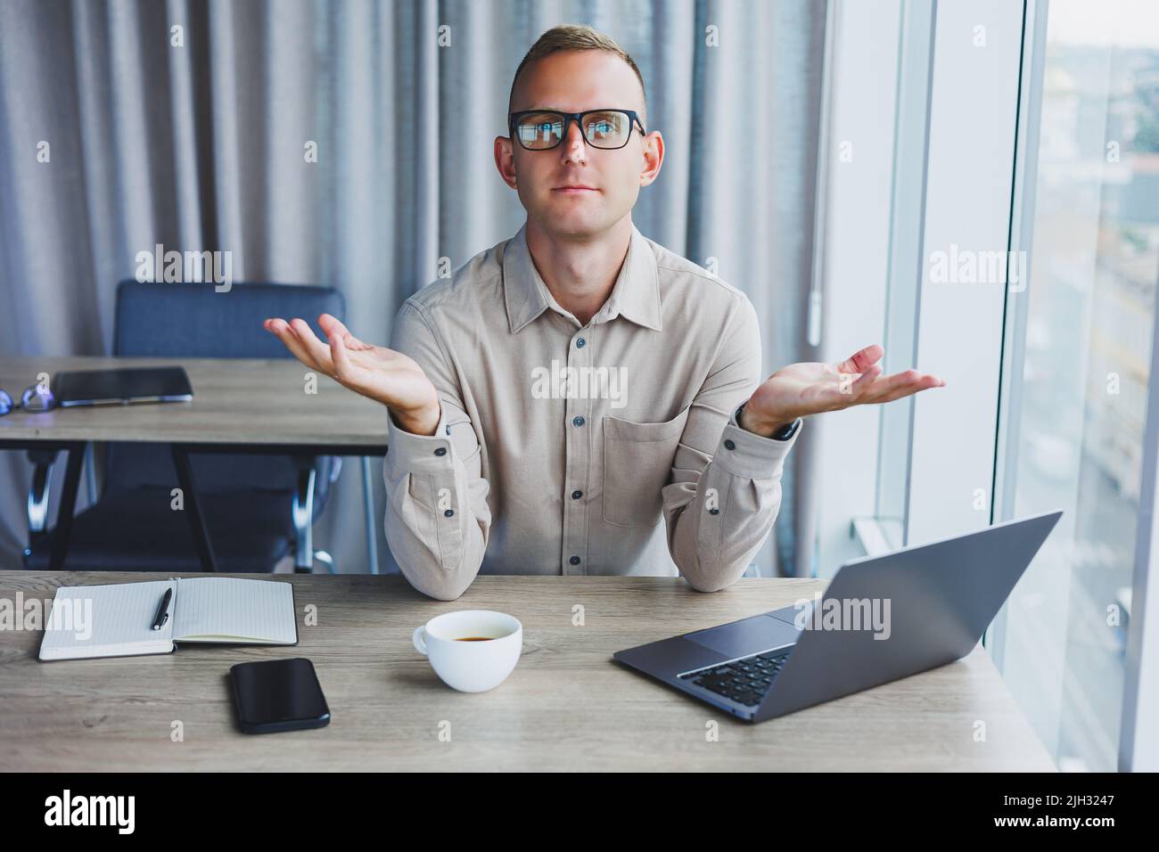 A businessman works on a laptop, a manager sits at a table in the ...