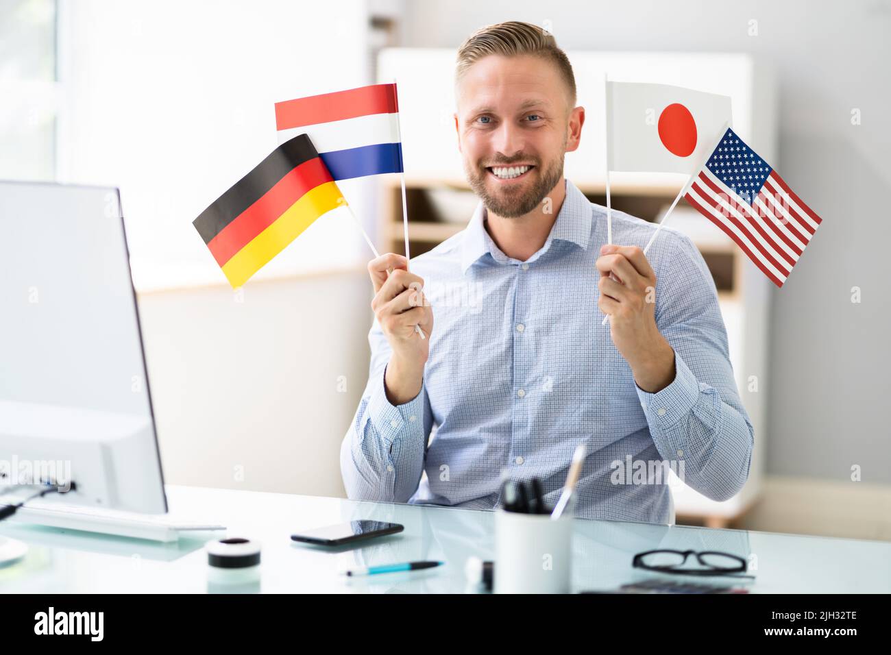 Online Foreign Language Course. Polyglot Man With Flags Stock Photo - Alamy