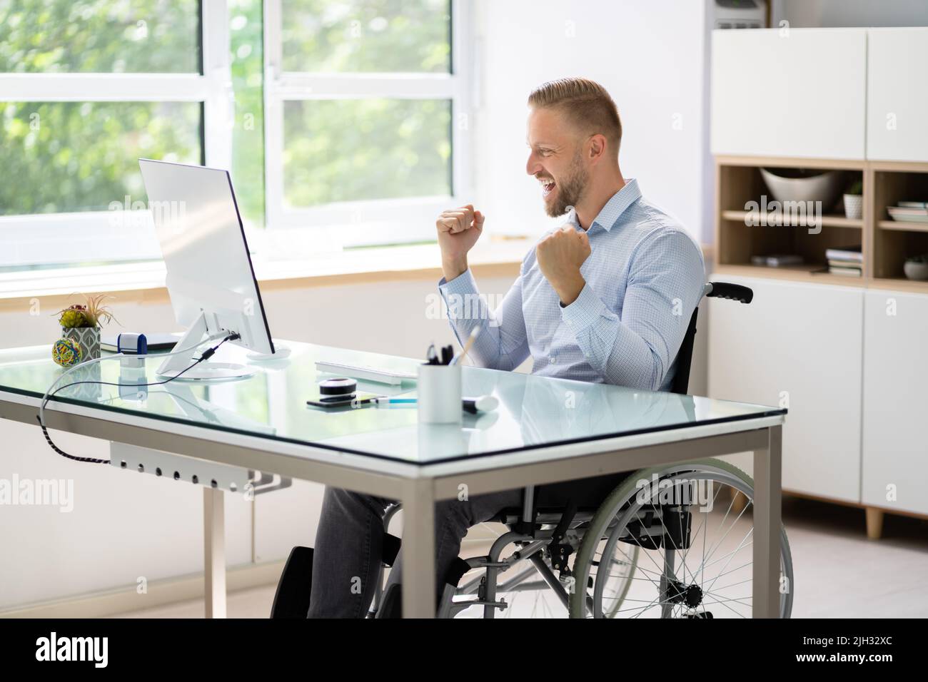 Disable Young Worker Using Computer. Physical Therapy In Wheelchair ...