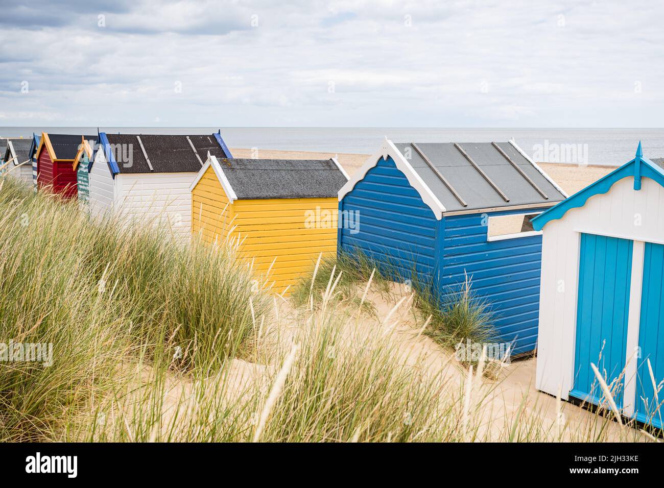 Southwold beach huts pictured over some beautiful sand dunes covered in ...