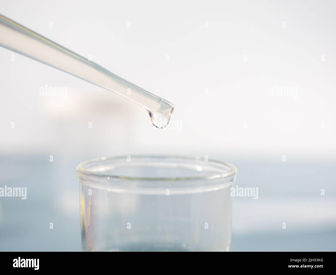Analytical chemistry - sample being pipetted into test tube for ...