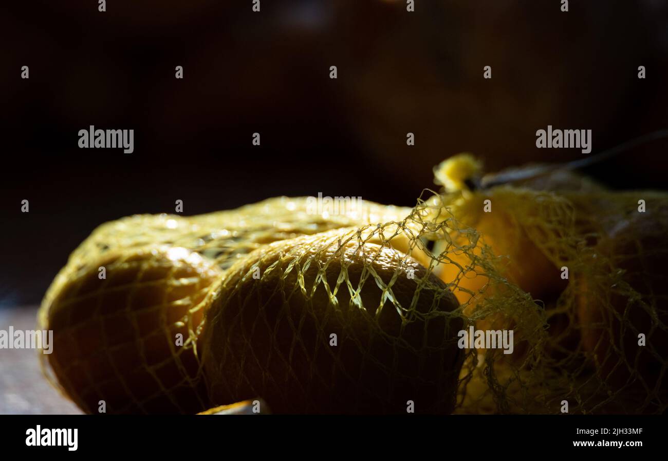 Lemons in the grid up close view. Fruit in the rays of the sun on a ...