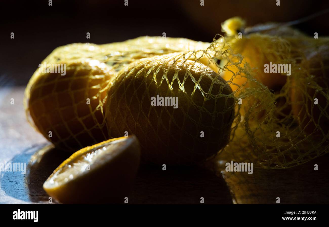 Lemons in the grid up close view. Fruit in the rays of the sun on a ...