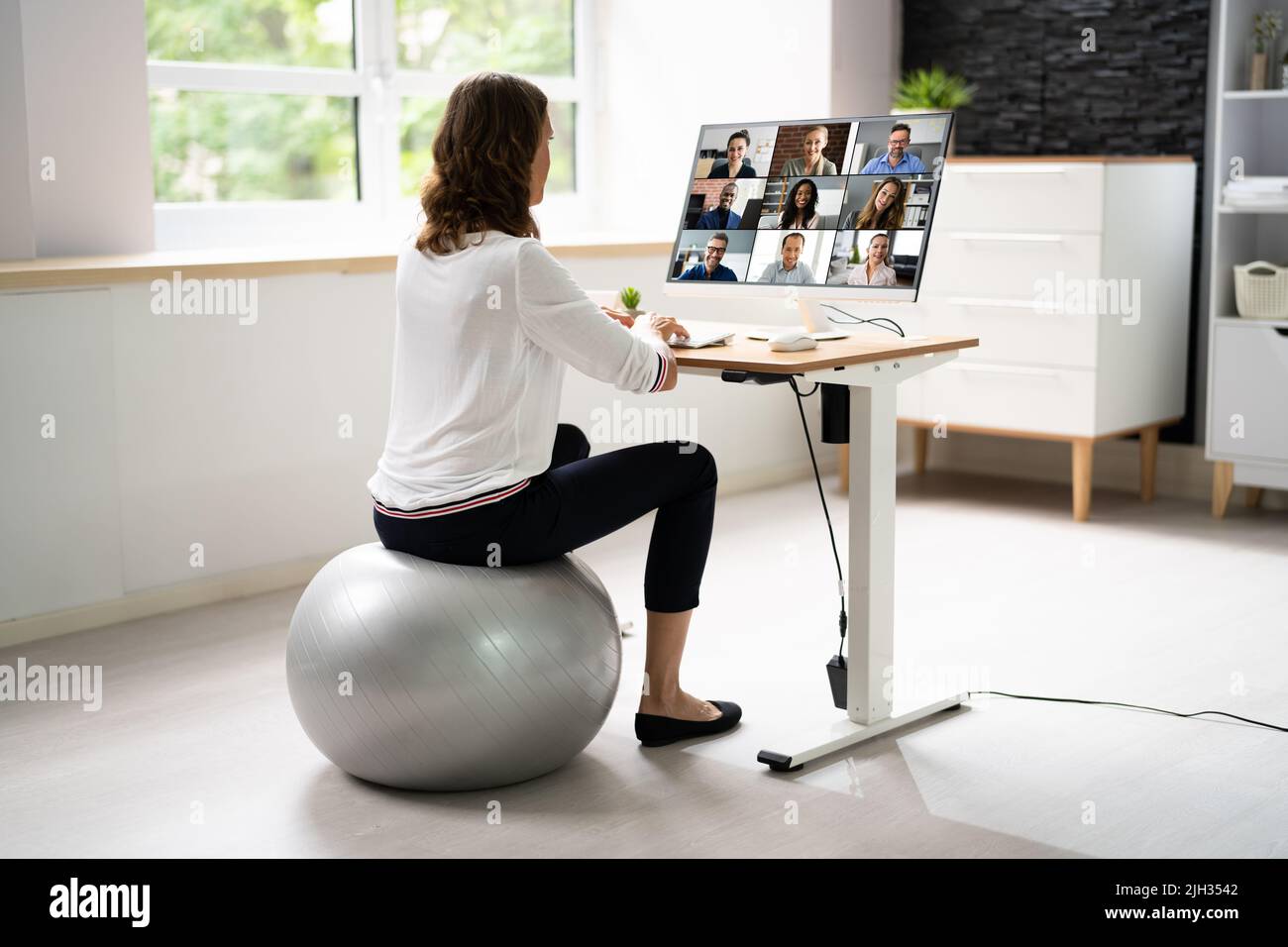 Correct Posture At Desk In Office Using Fitness Ball Stock Photo - Alamy