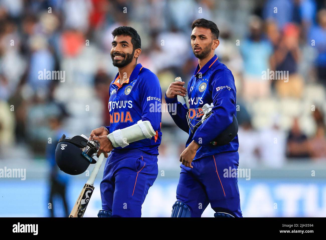 Jasprit Bumrah of India is all smiles as he leaves the field at the end ...