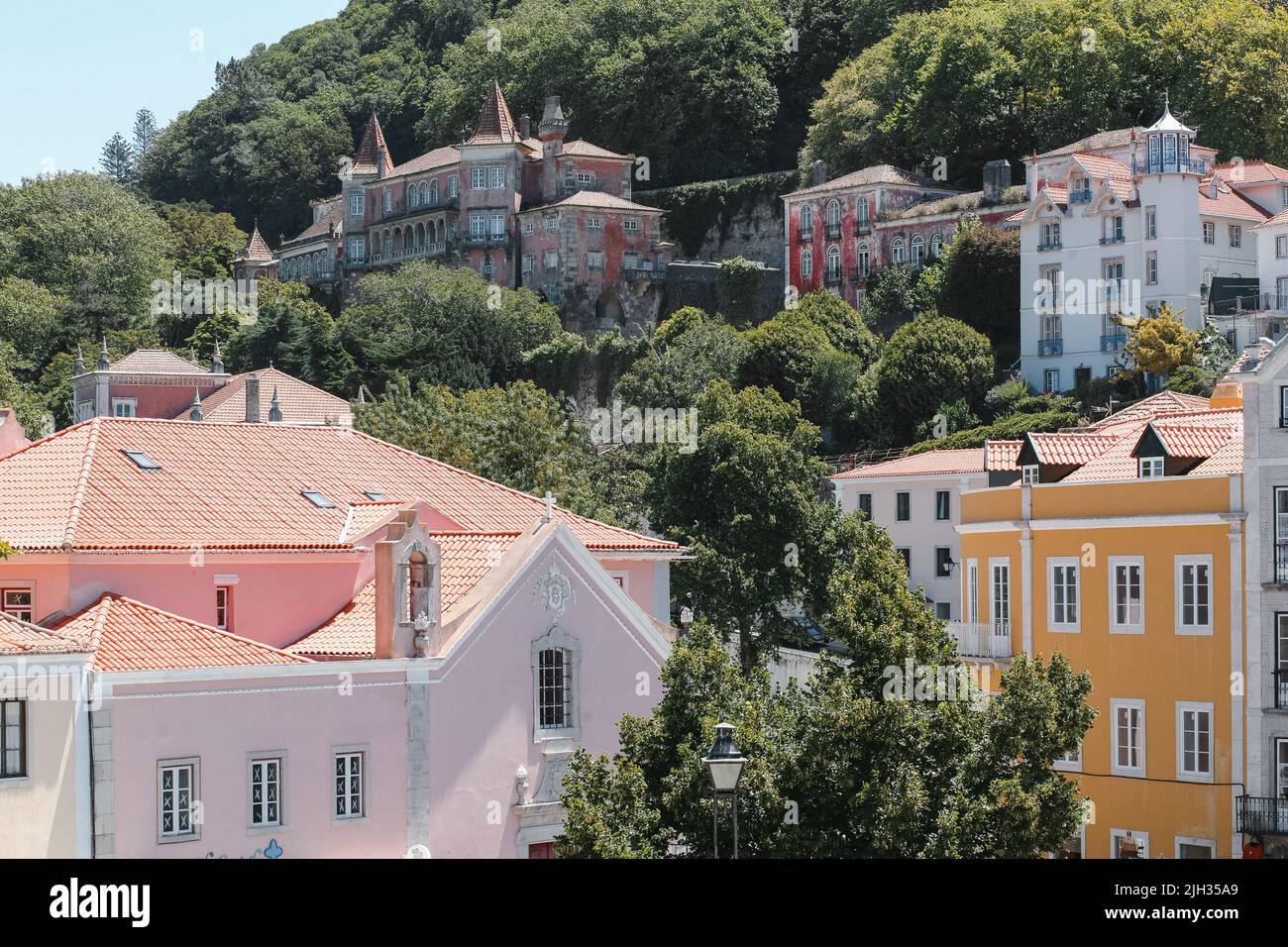 Buildings of the old city on a mountain slope in a dense green forest ...