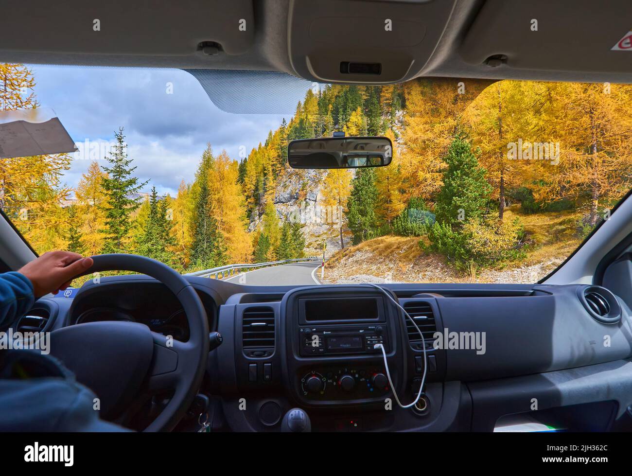 A view on the Alps through the windscreen of the car while driving on ...