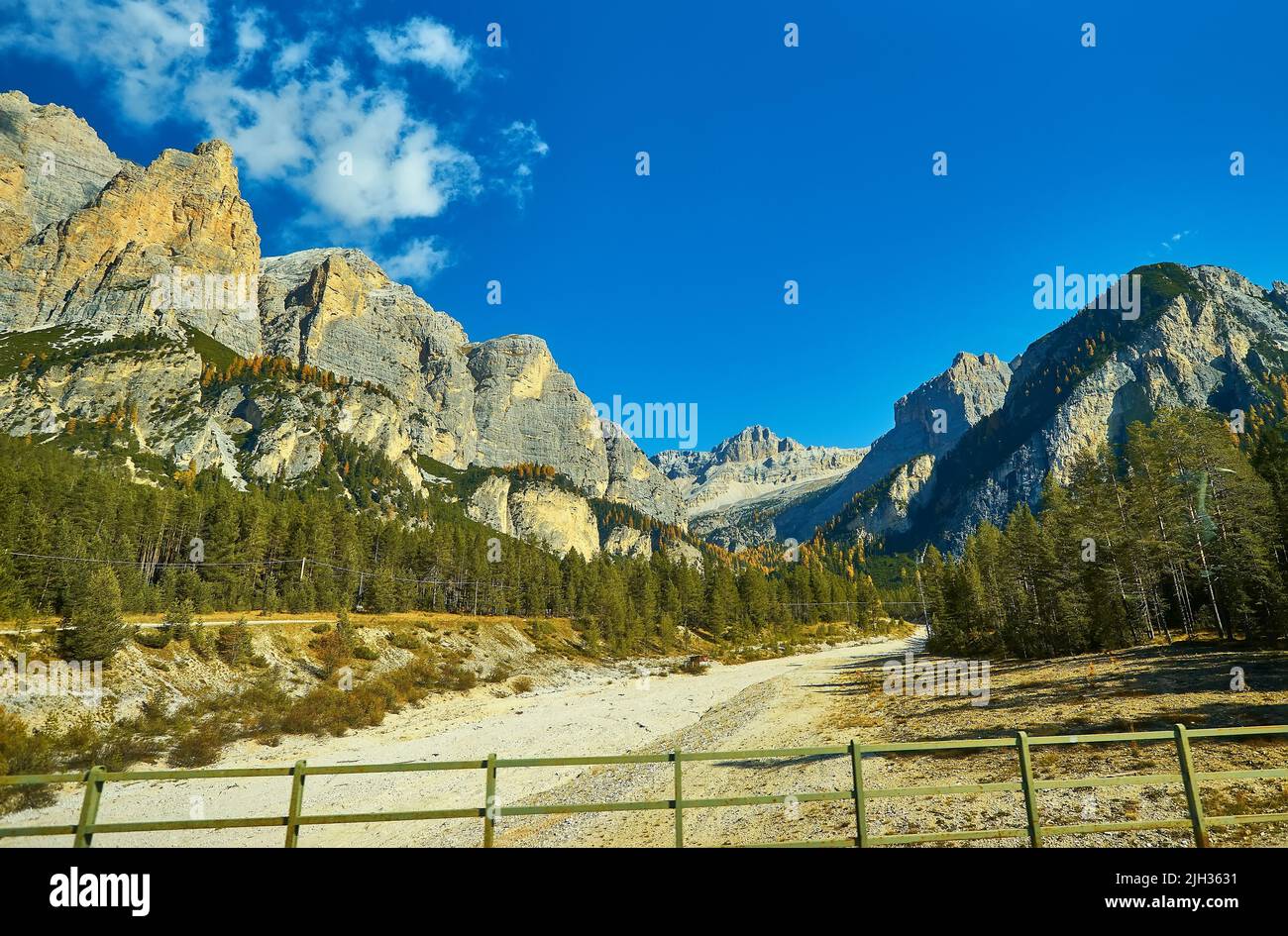 Stunning alpine Landscape at sautumn sunny day. Alpine meadow and road ...