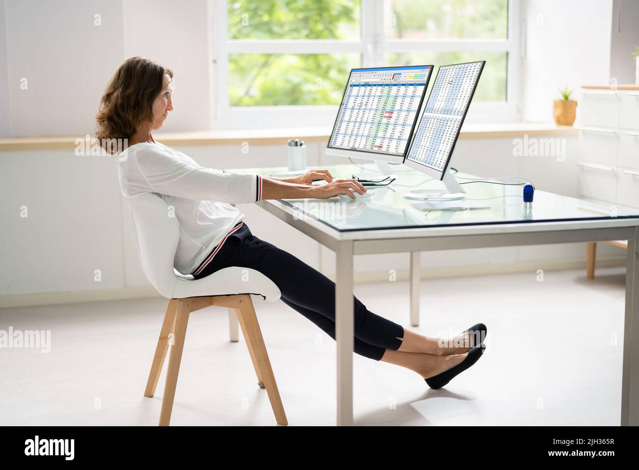 Bad Posture Sitting In Office Chair At Computer Desk Stock Photo - Alamy