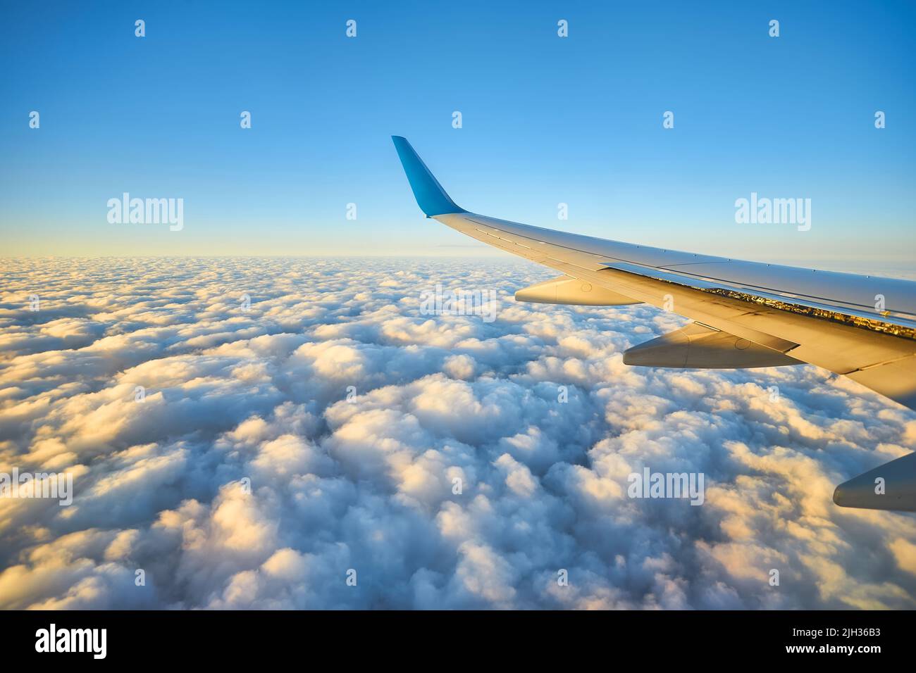 Spectacular view of a sunset above the clouds from airplane window ...