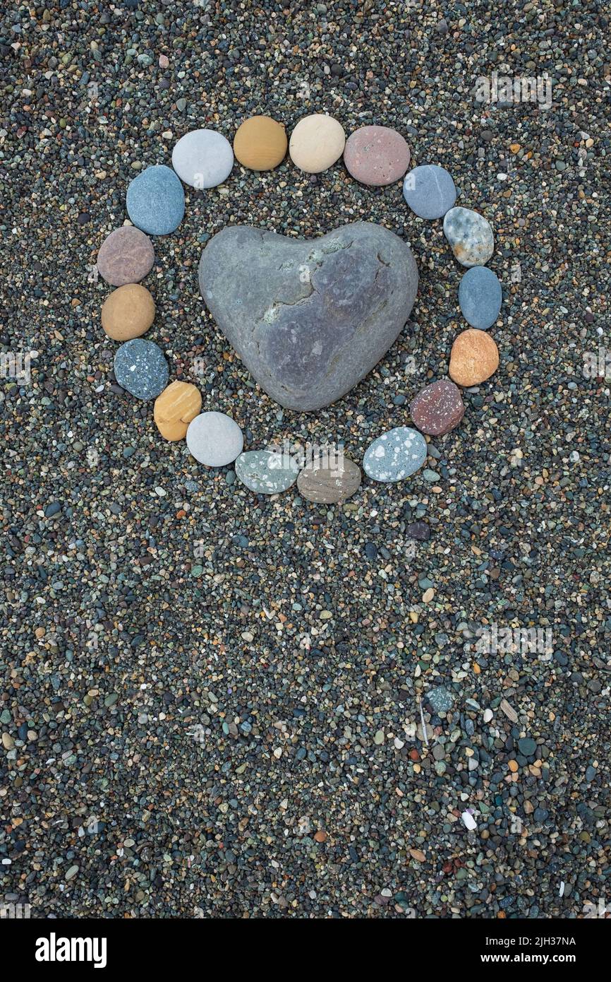 Heart shaped sea stone pebble on sandy beach Stock Photo - Alamy