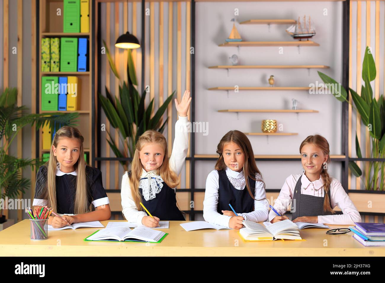Young female students in school uniforms before the lesson in the ...