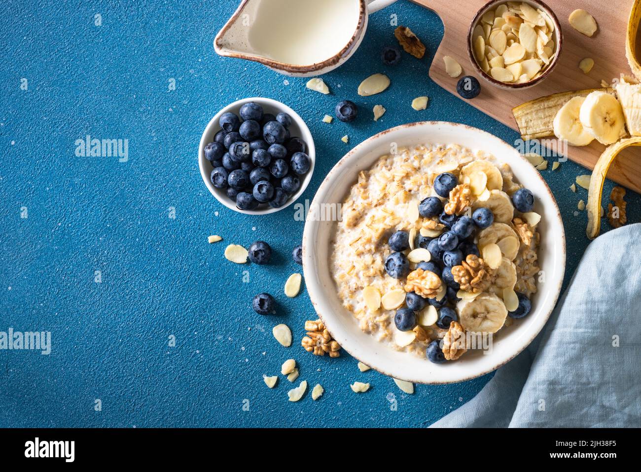Oatmeal porrige in craft bowl at white background Stock Photo - Alamy