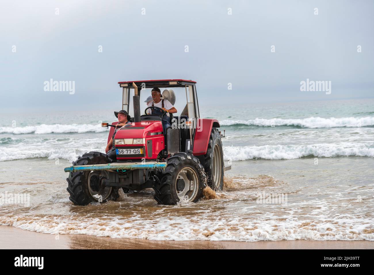 Fishermans working in Fonte da Telha beach in Almada Portugal Stock ...