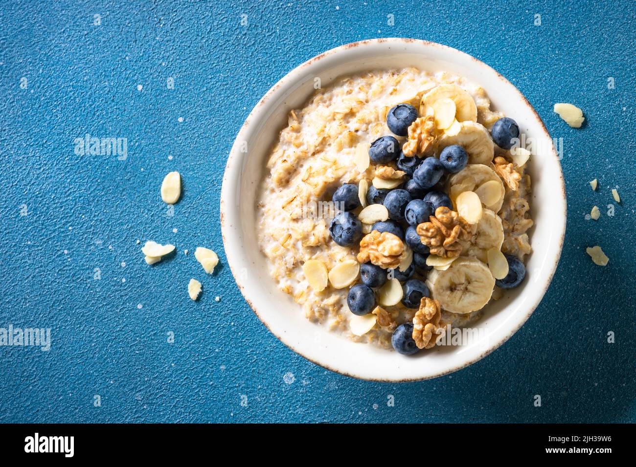 Oatmeal porrige in craft bowl at white background Stock Photo - Alamy