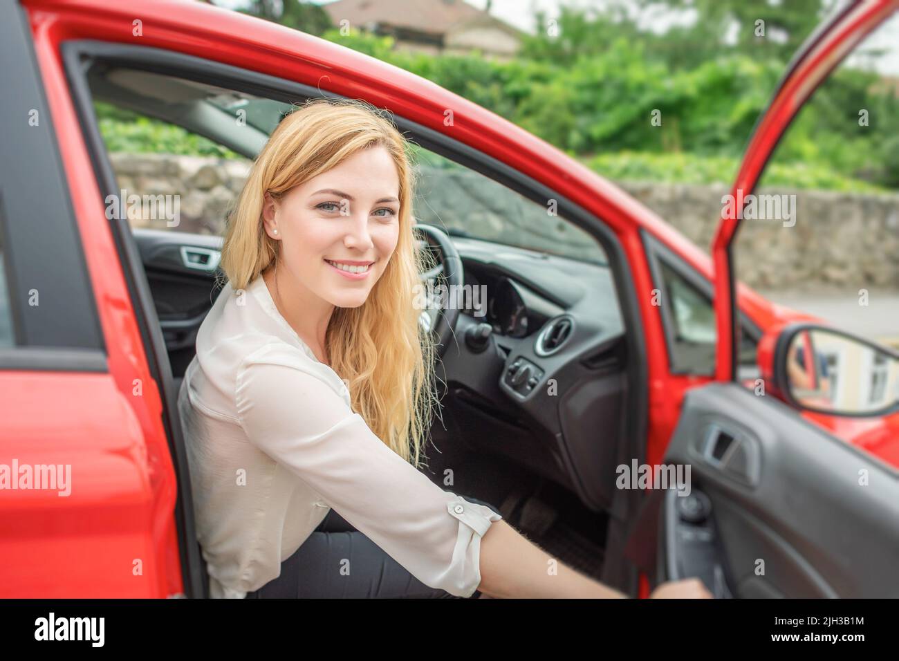 Beautiful blonde driving a car Stock Photo - Alamy