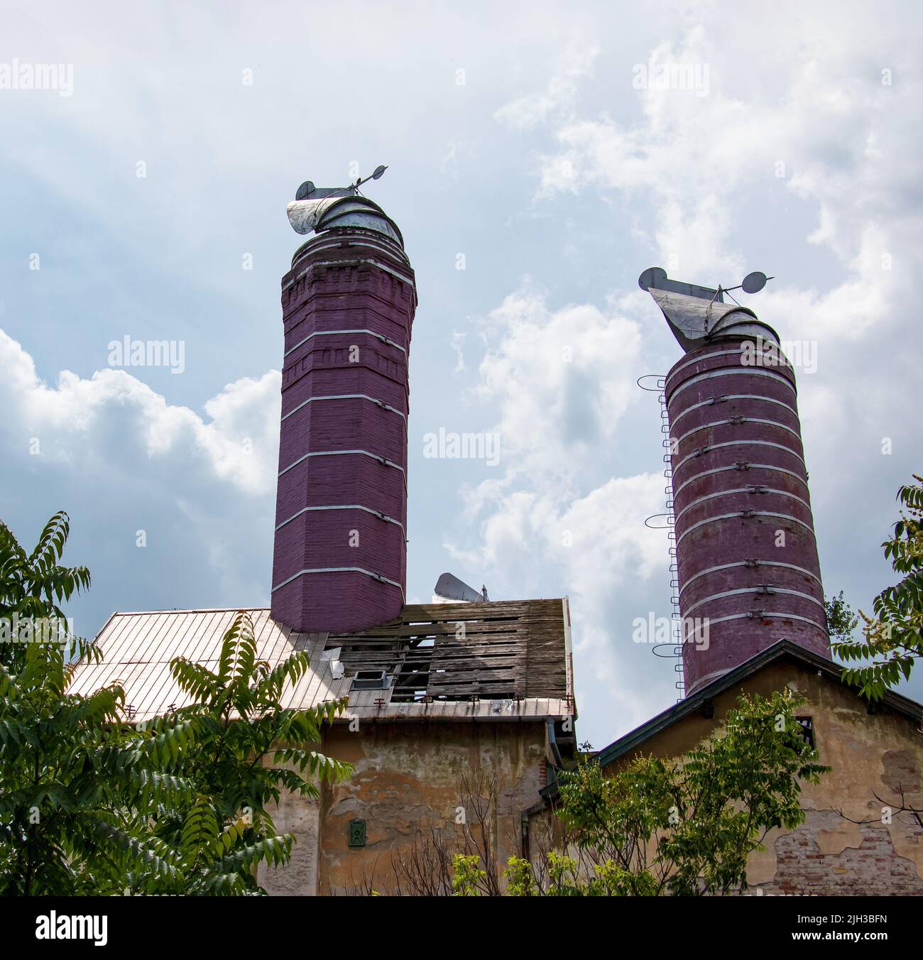 Original chimneys of an old brewery against the blue sky. The old ...