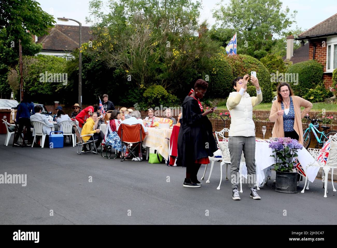 Woman Taking Photograph on Smartphone at Street Party Celebrating Queen ...