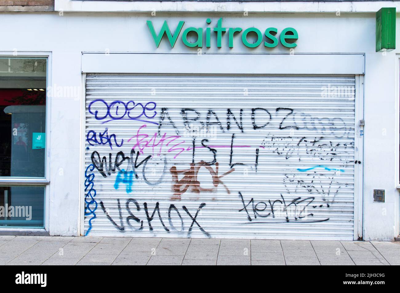 Close store shutter vandalised with graffiti Stock Photo - Alamy