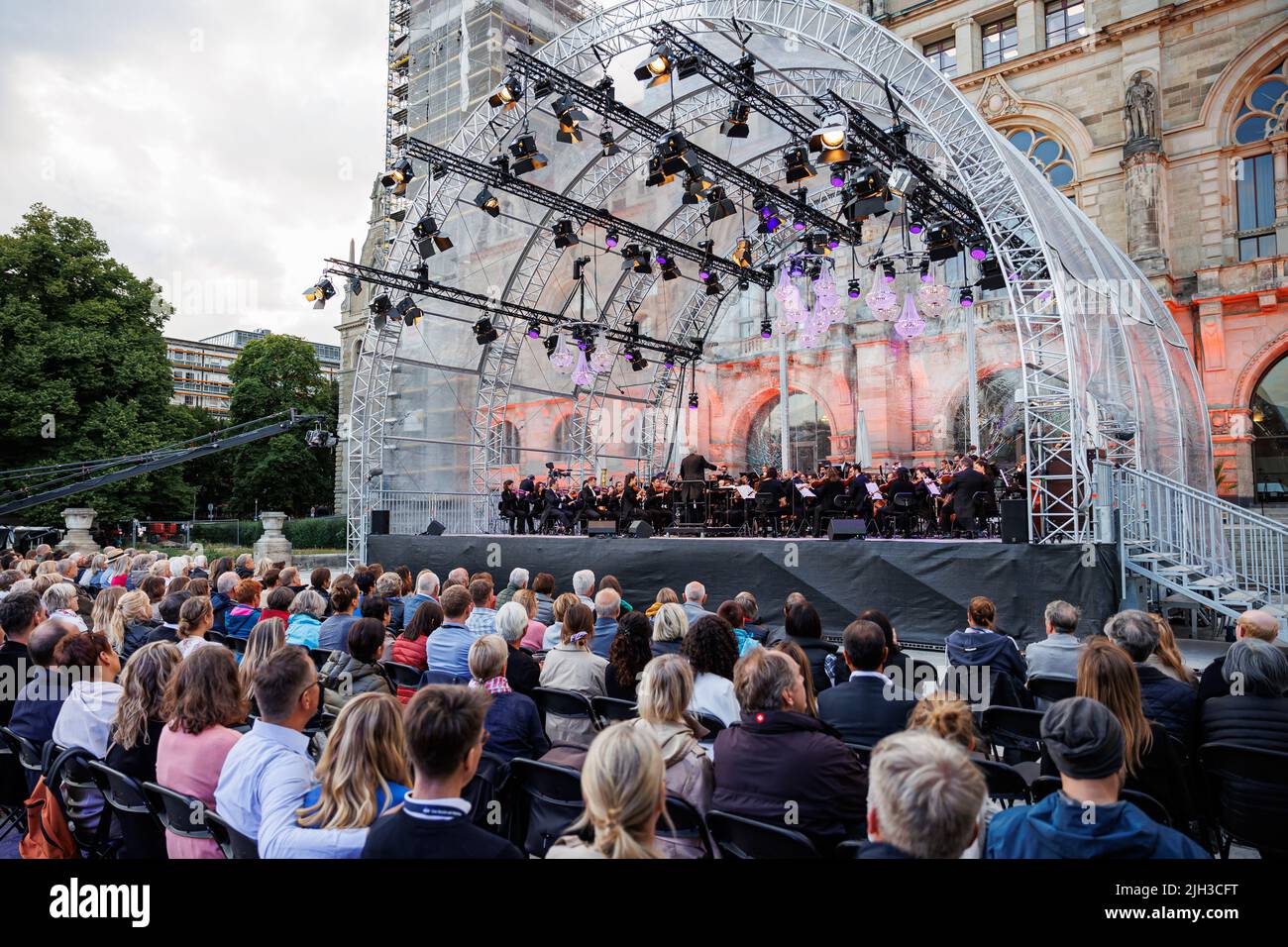 Hanover, Germany. 14th July, 2022. Visitors sit in front of the stage ...