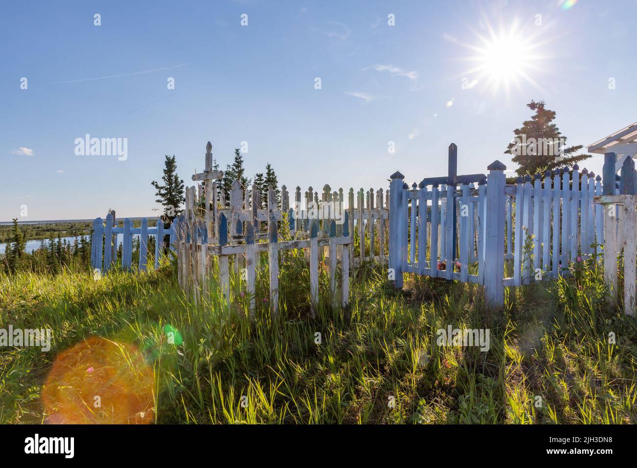 Wooden-fenced gravesites in cemetery in summer, in the northern ...