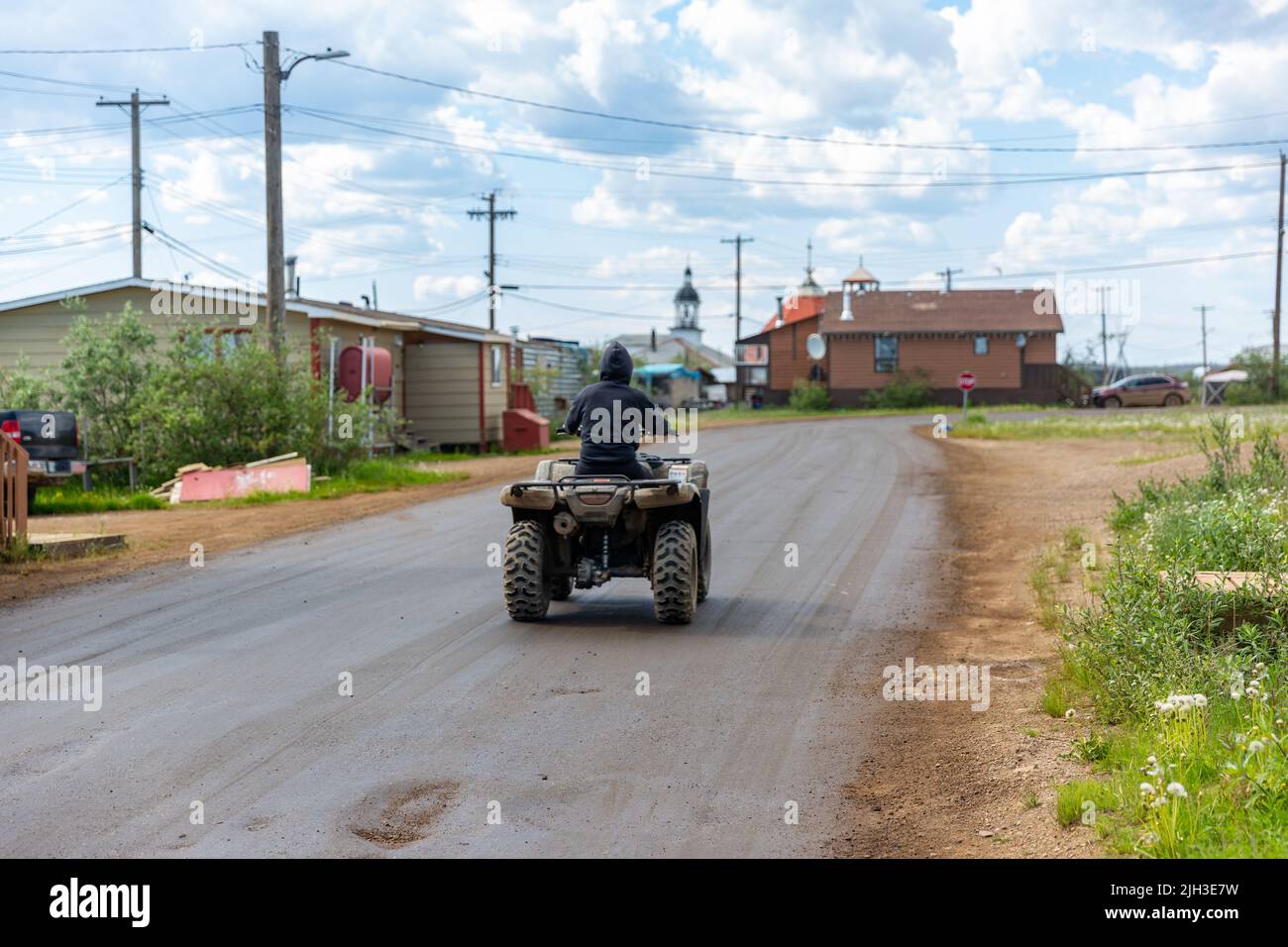 Person riding a four-wheeler in summer on the dirt road of the northern ...