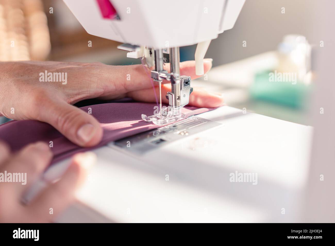 close-up of sewing machine needle sewing a piece of fabric Stock Photo ...