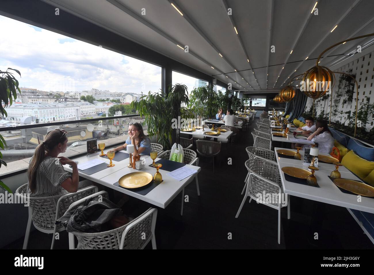 Moscow. Girls have a rest on a summer verandah of cafe 'Pifagor'na ...
