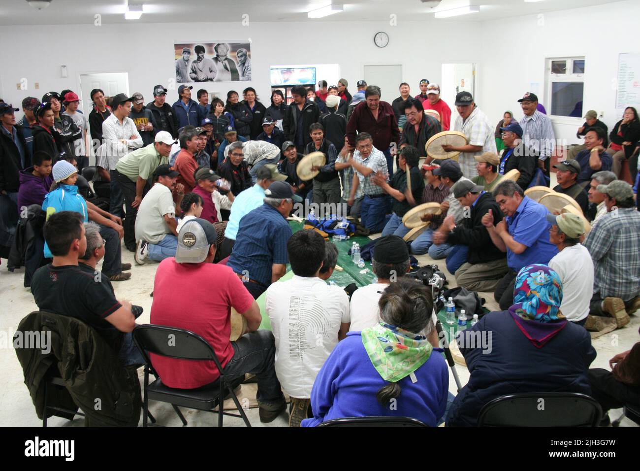Indigenous Dene men playing drums and traditional handgames in the ...