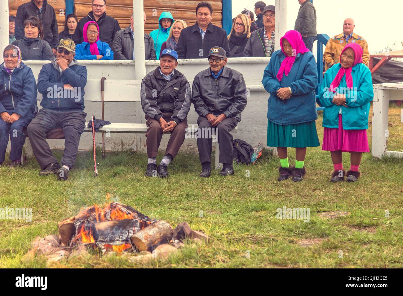 Dene elders and other onlookers at a fire feeding ceremony, in the ...