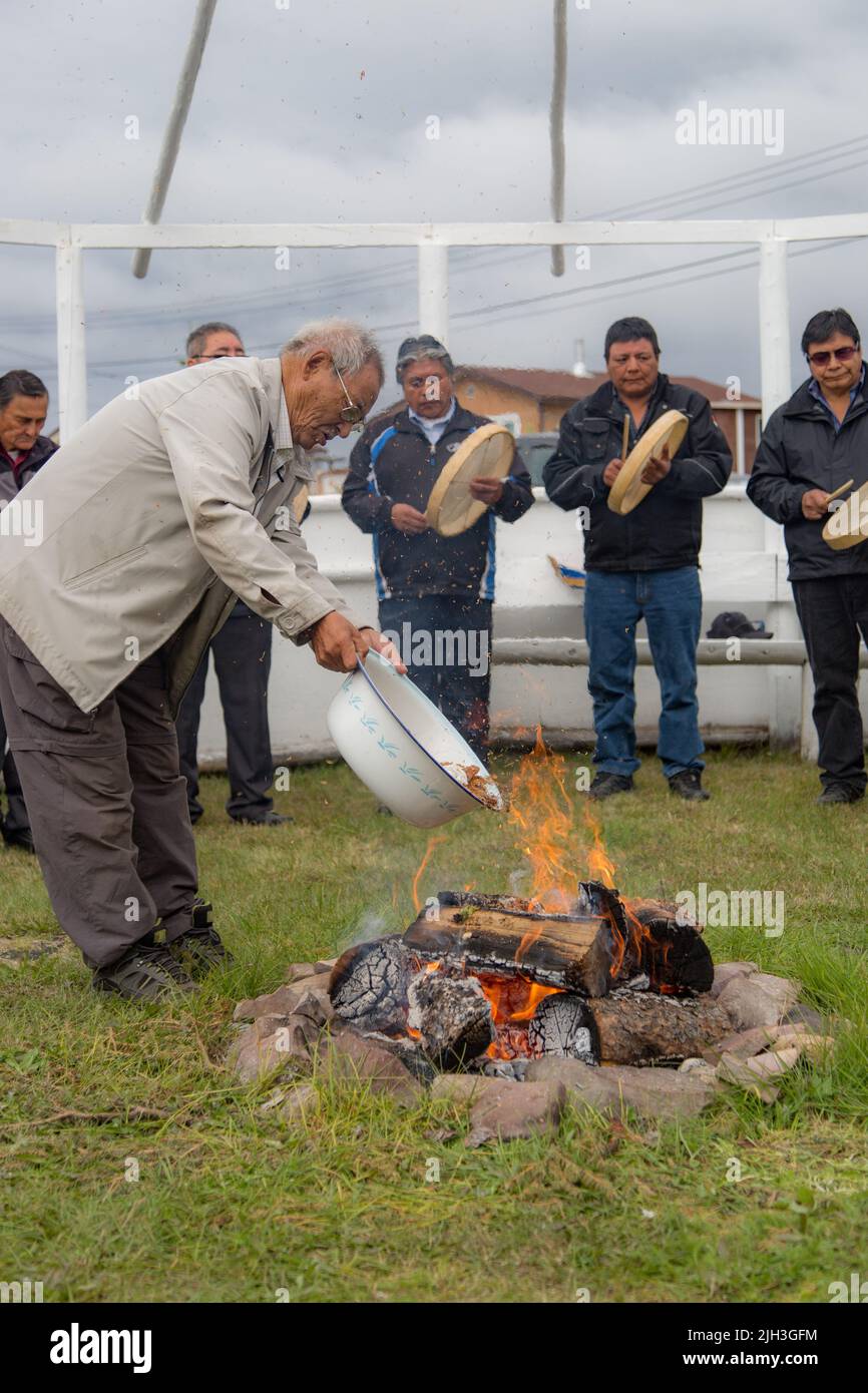 Elder Dene man feeding the fire at Indigenous traditional fire feeding ...