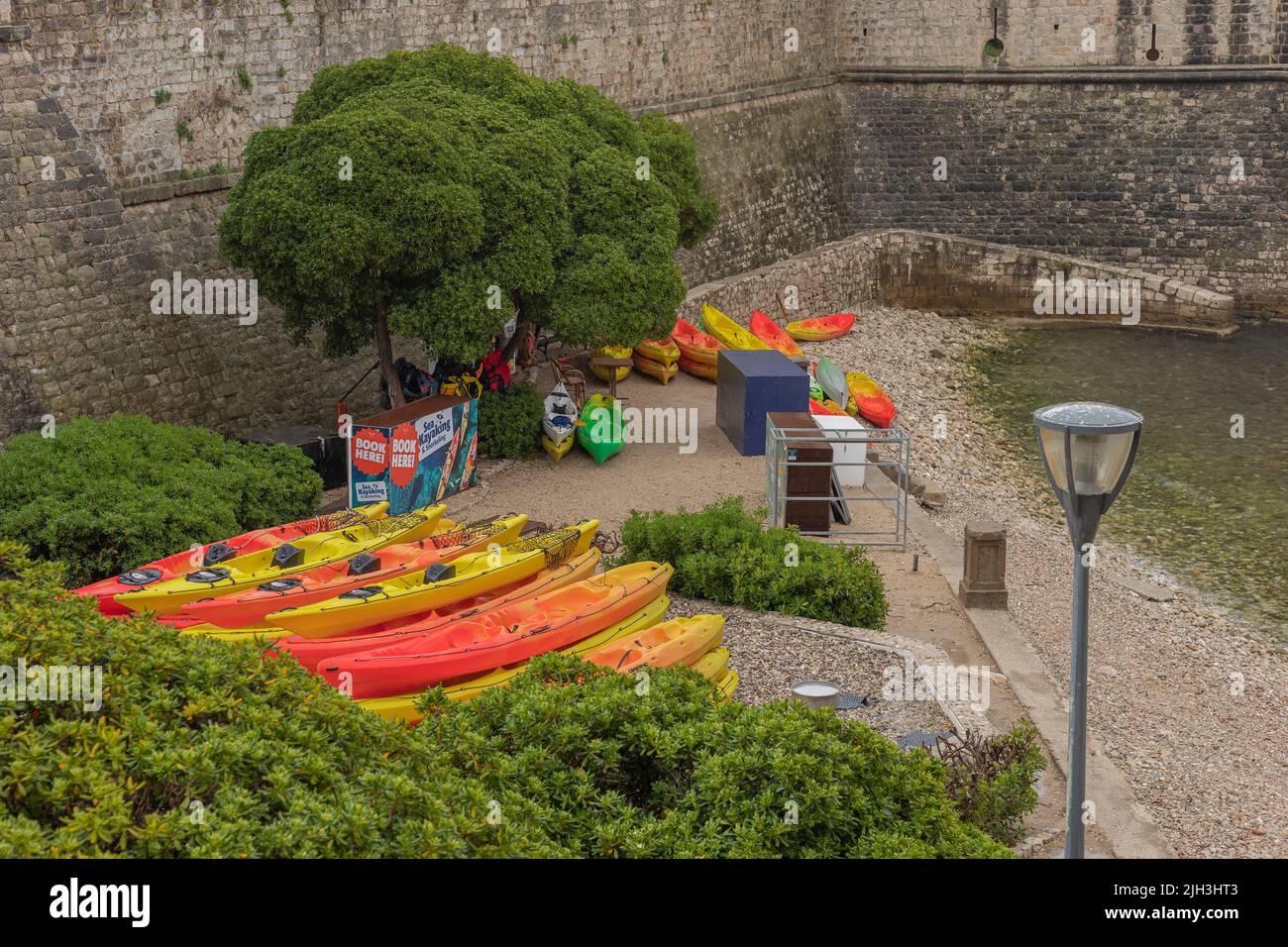 booking station for Sea kayaking and snorkelling on a beach with yellow ...