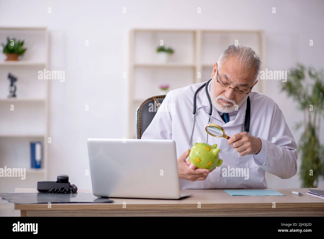 Old doctor in retirement concept Stock Photo - Alamy