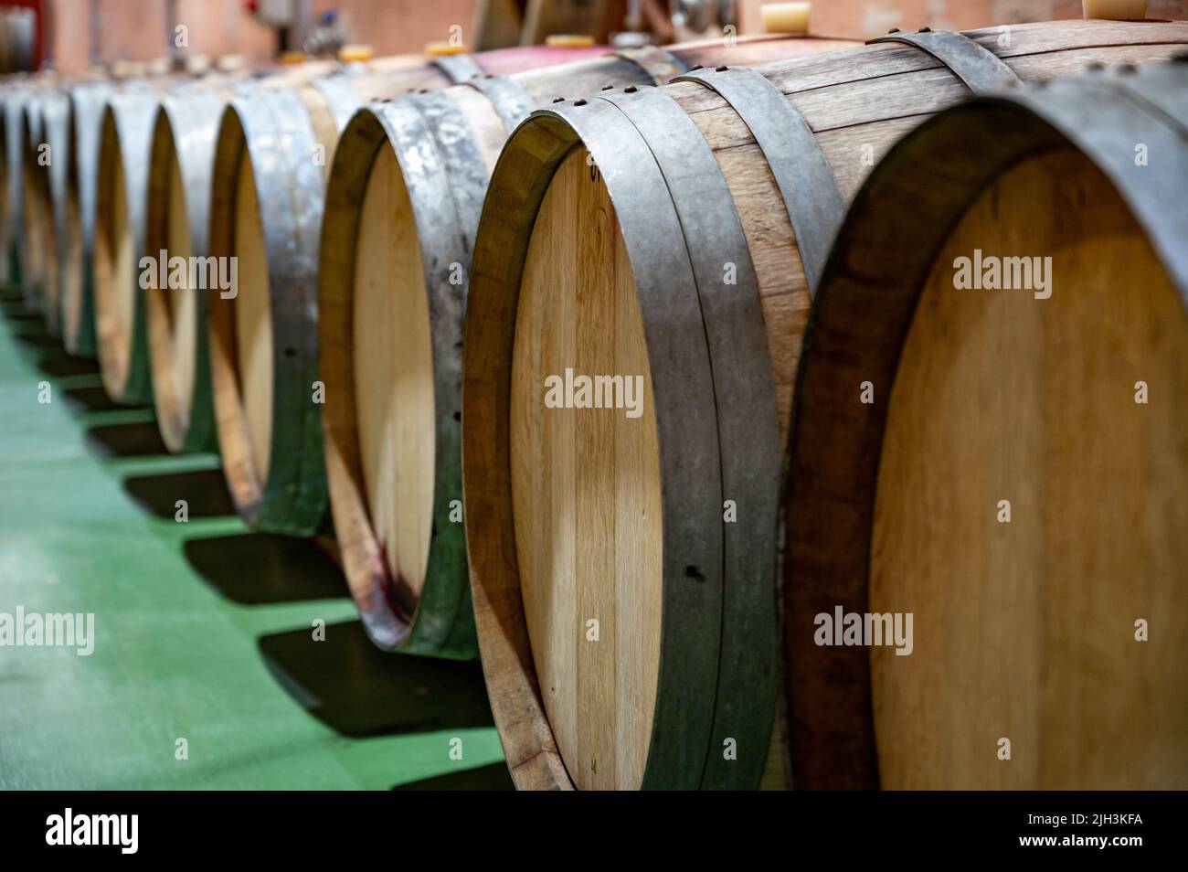 Making wine on traditional bodega in steel tanks and old wooden barrels ...