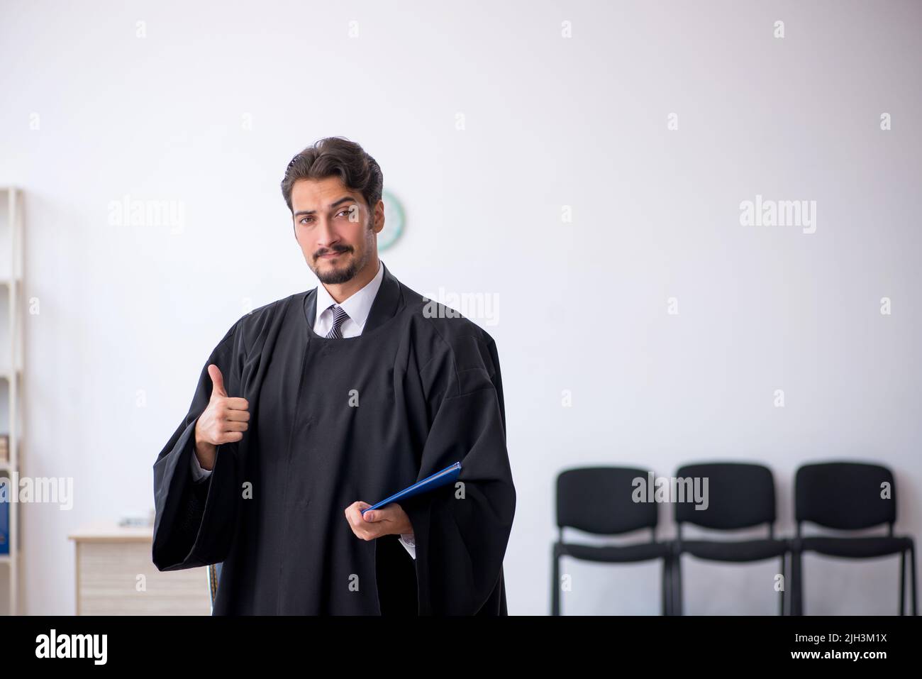 Young judge working in the courthouse Stock Photo - Alamy