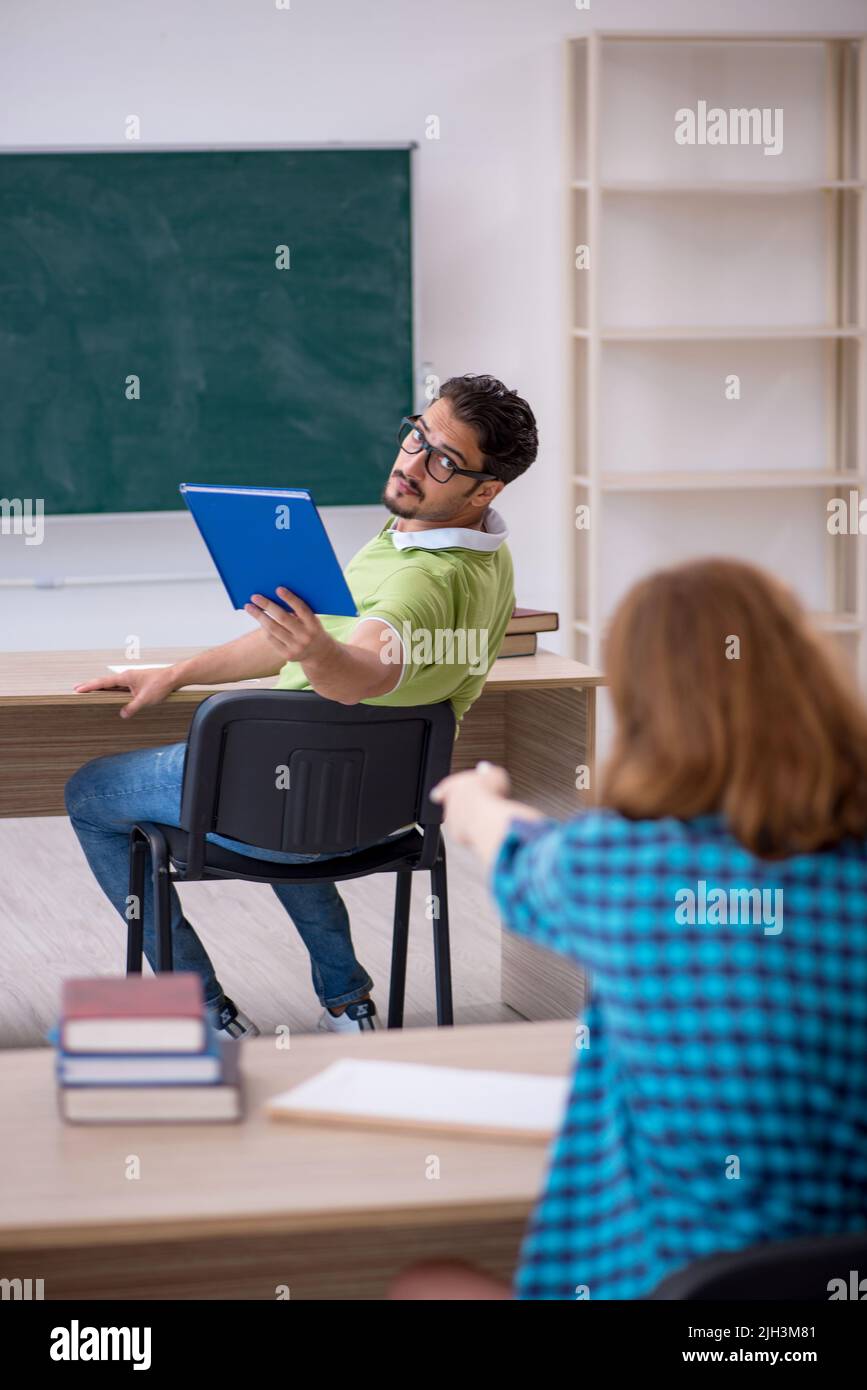 Two students sitting in the class Stock Photo - Alamy