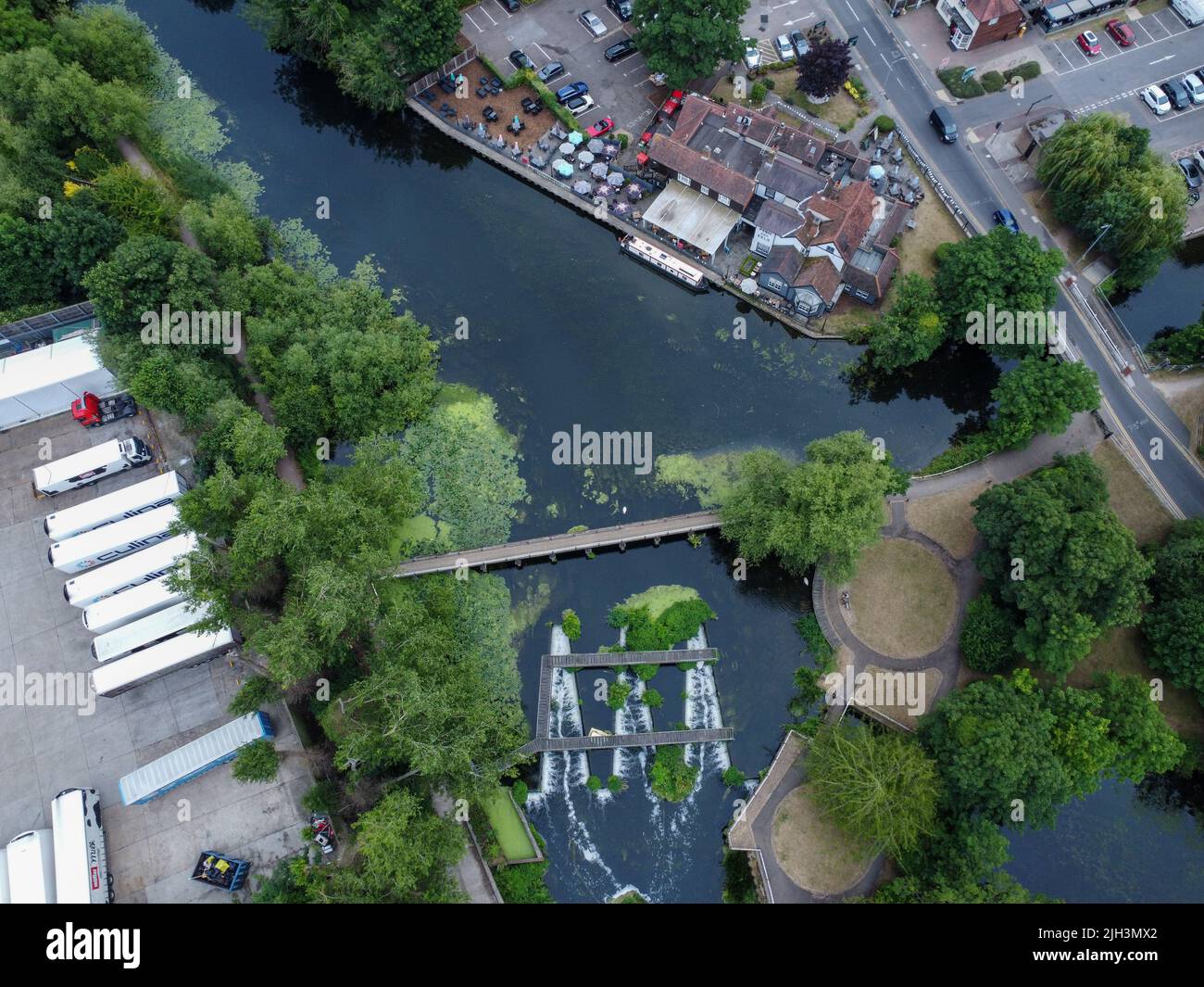 Aerial view of weir and pub on a river in Hoddesdon, with clear ...
