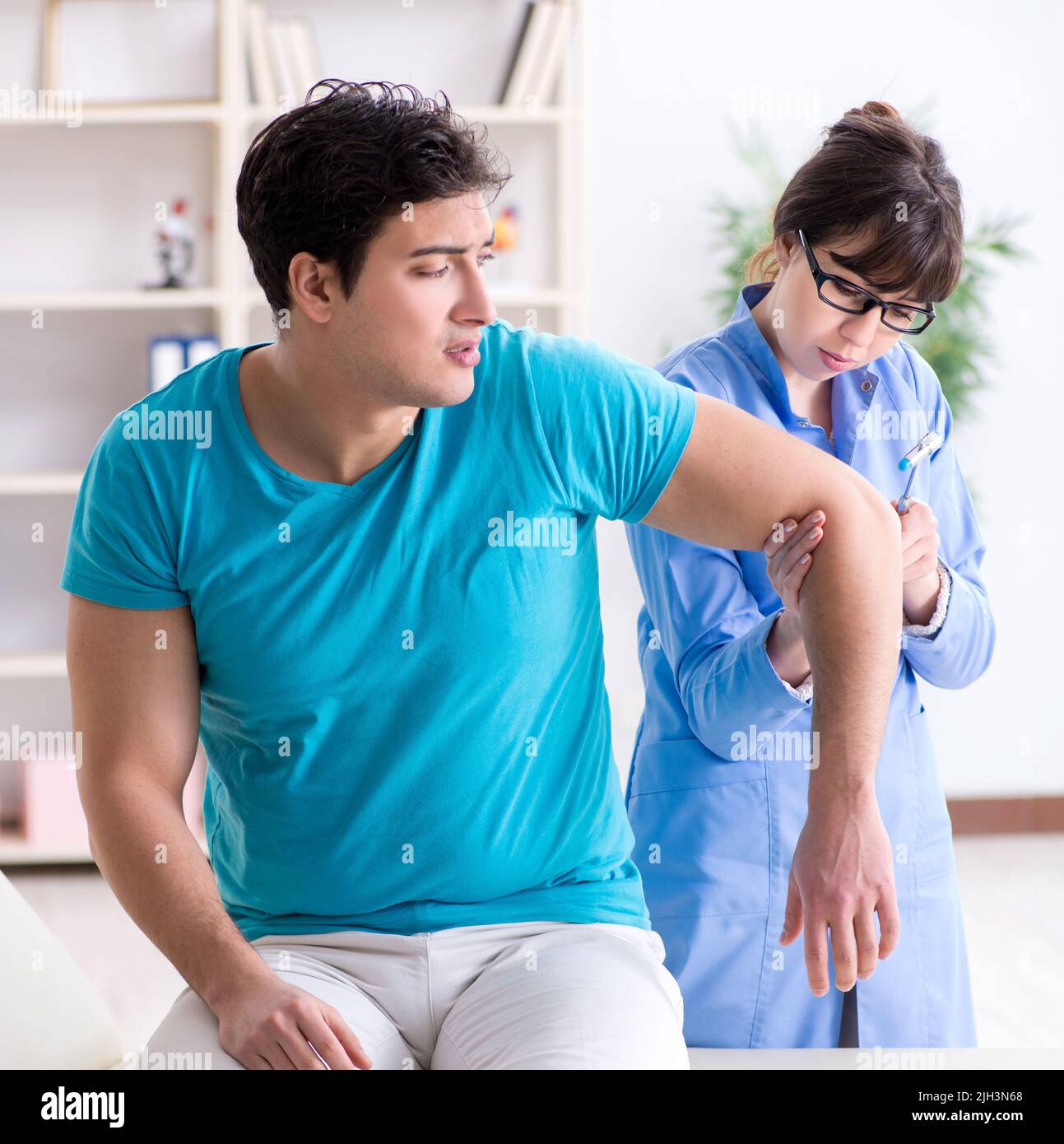 The doctor checking nerve reflexes with hammer Stock Photo - Alamy