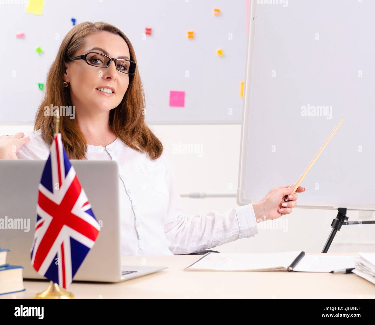 Female english teacher in the classroom Stock Photo - Alamy