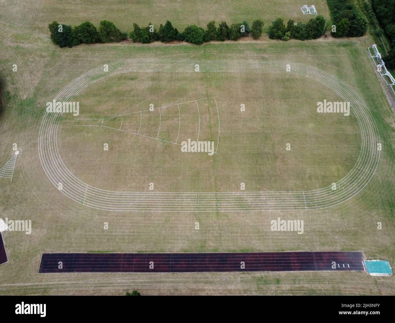 Aerial shot of a school sports field and running track in Hertford UK ...